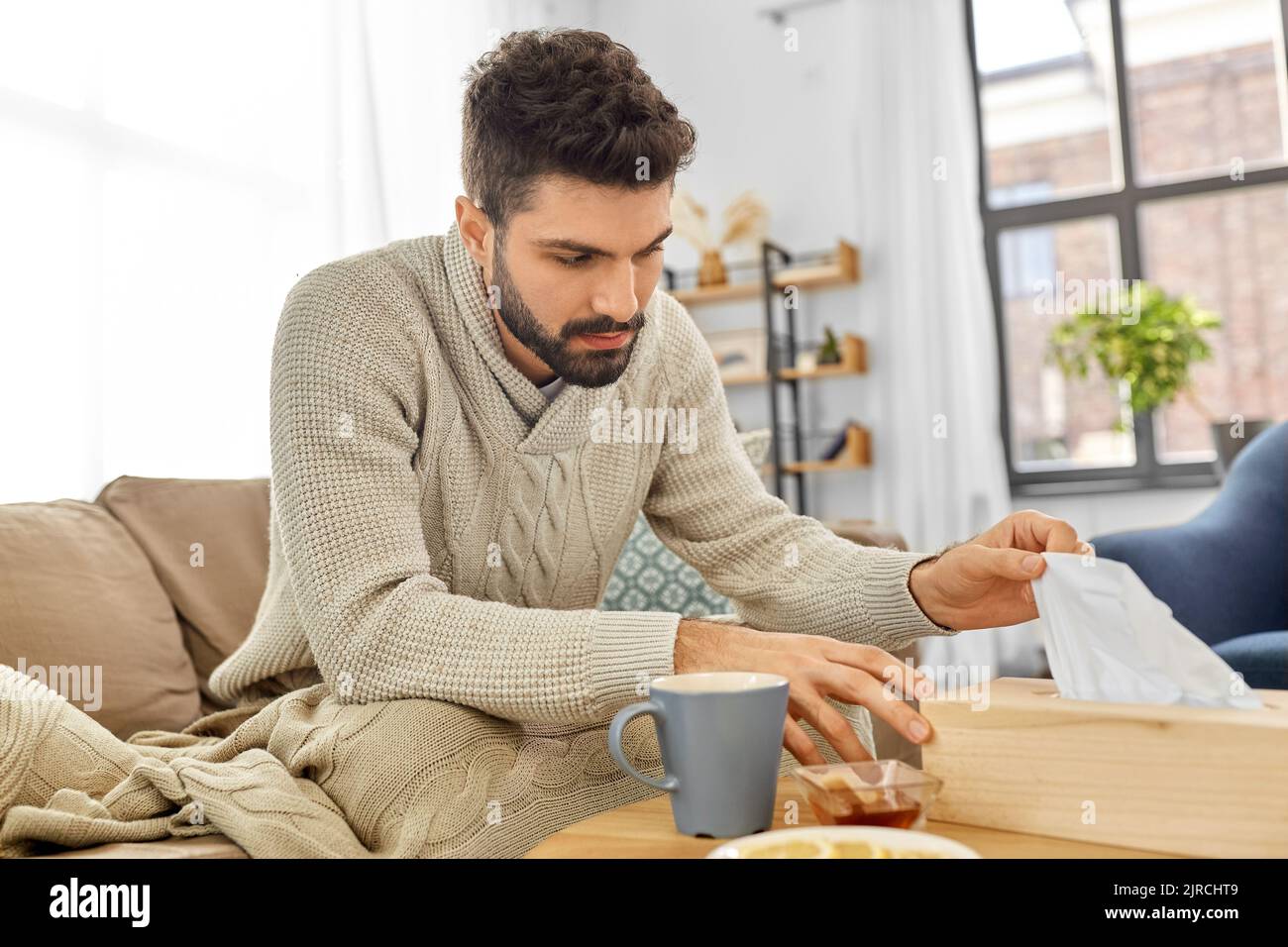 sick man taking paper tissue from box at home Stock Photo - Alamy