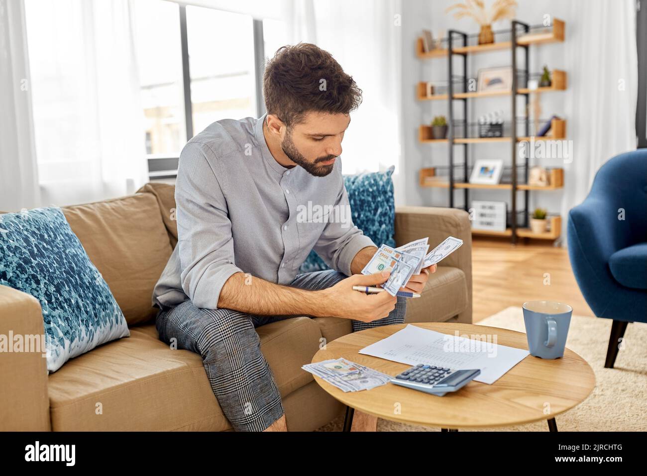 man with money and calculator filling papers Stock Photo - Alamy