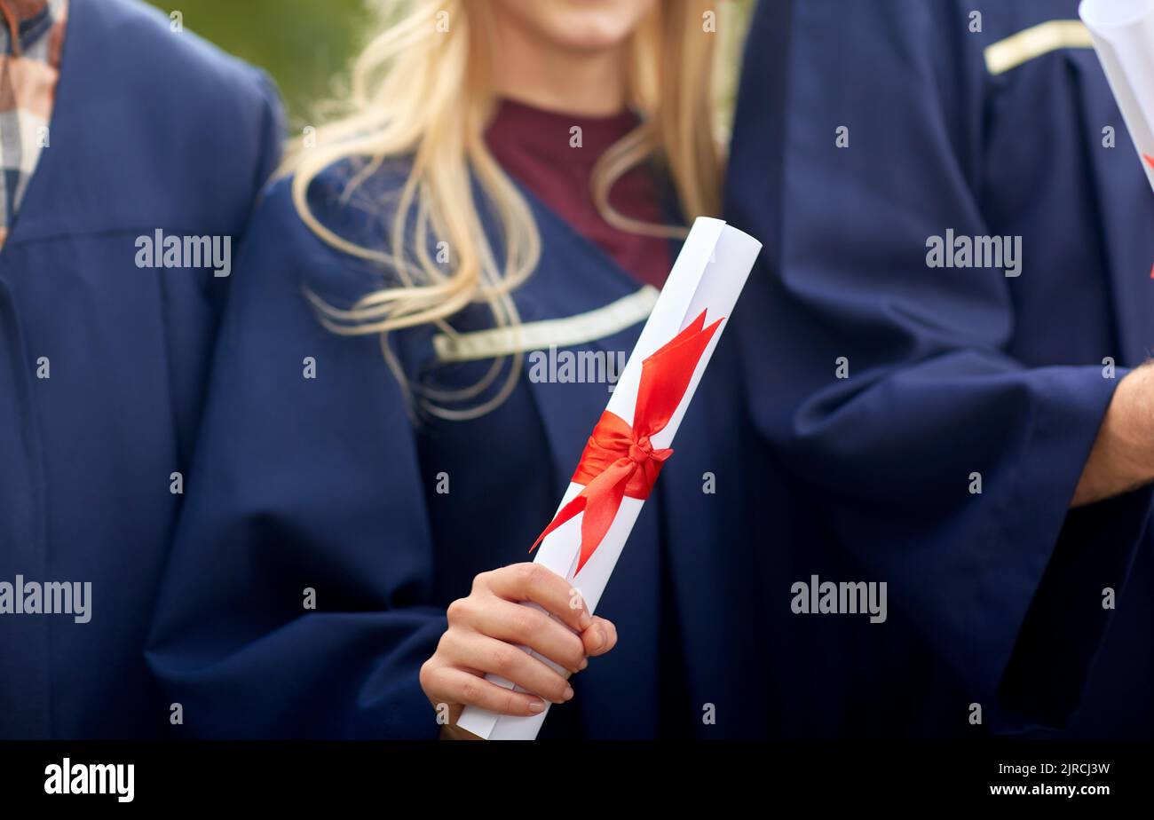 graduate students in mortar boards with diplomas Stock Photo - Alamy