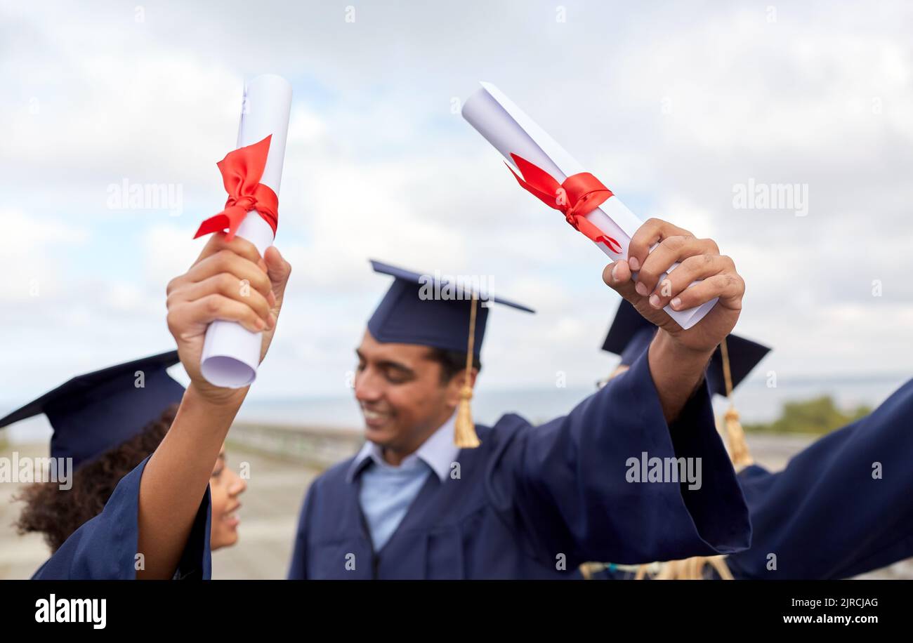 graduate students in mortar boards with diplomas Stock Photo - Alamy