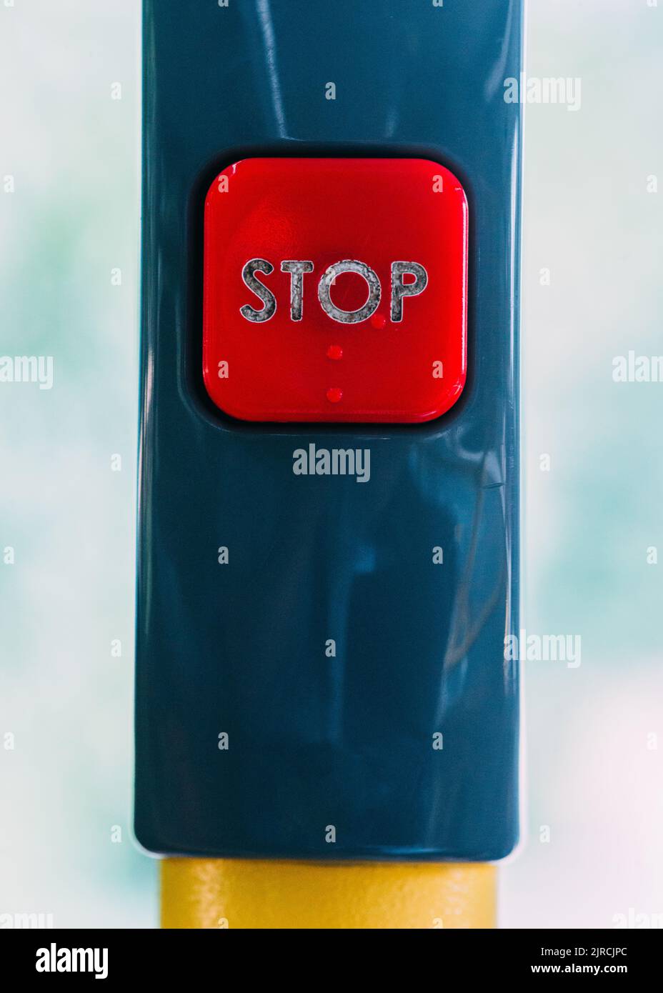 A vertical closeup of red stop button-bell in a bus Stock Photo - Alamy