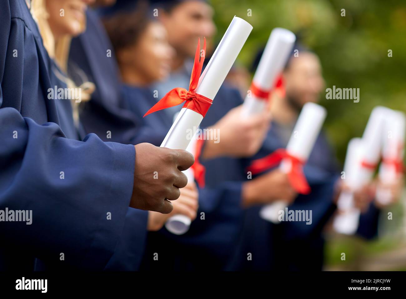 graduate students in mortar boards with diplomas Stock Photo - Alamy