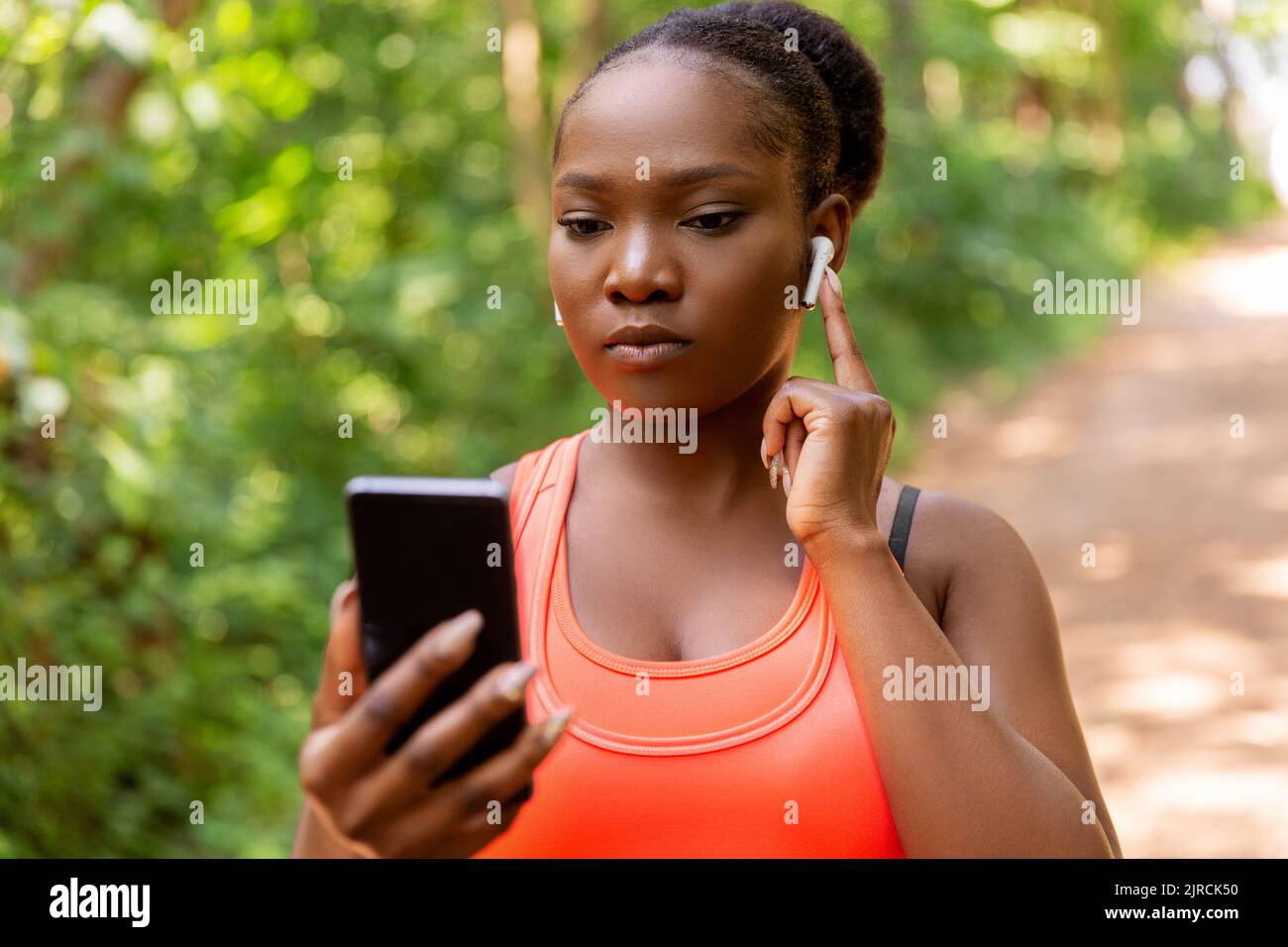 african american woman with earphones and phone Stock Photo - Alamy