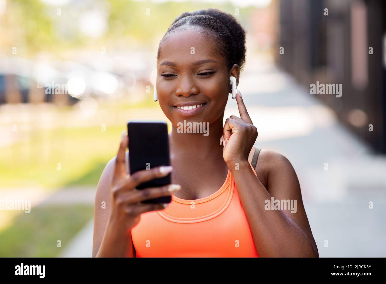african american woman with earphones and phone Stock Photo - Alamy