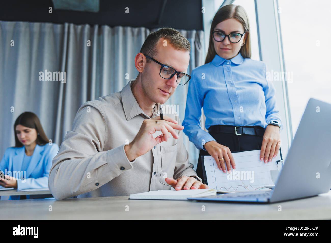 Two manager employees in a modern office, Europeans man and woman ...