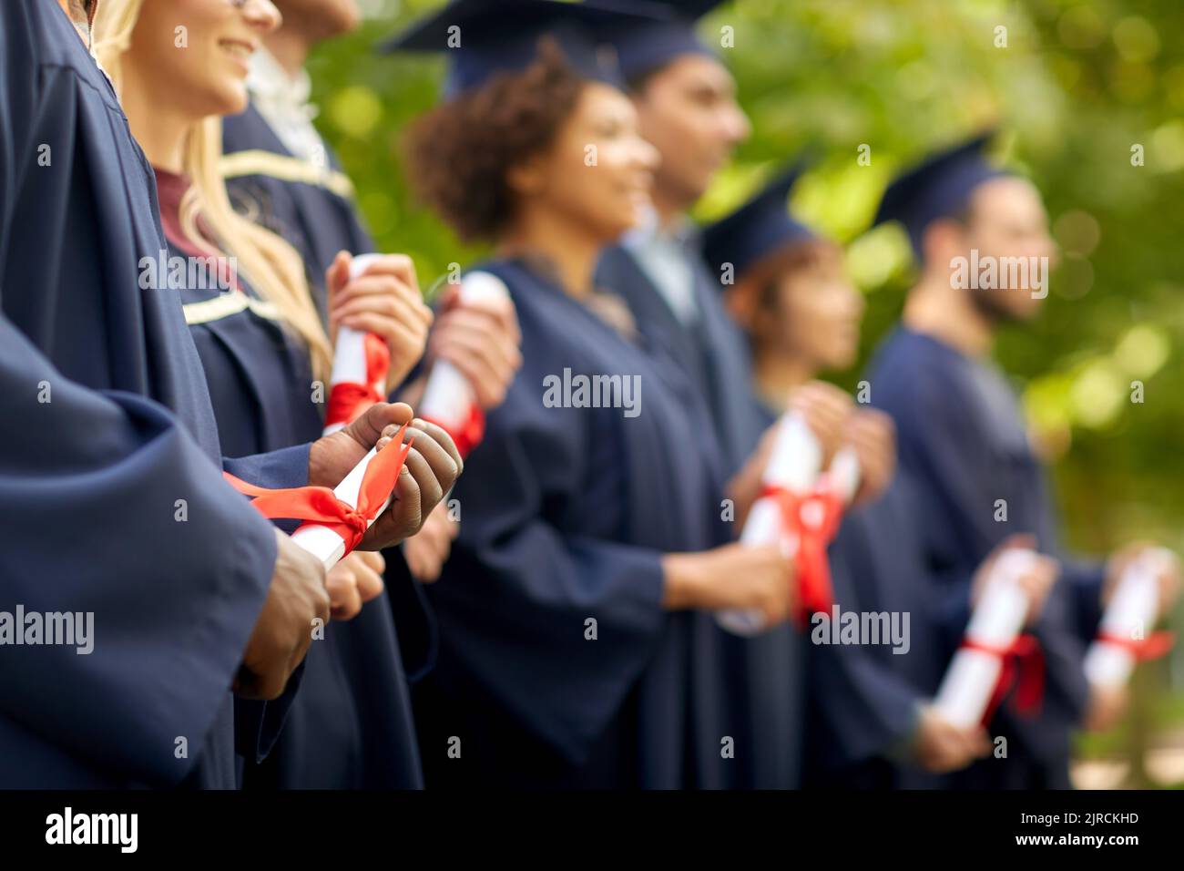 graduate students in mortar boards with diplomas Stock Photo - Alamy
