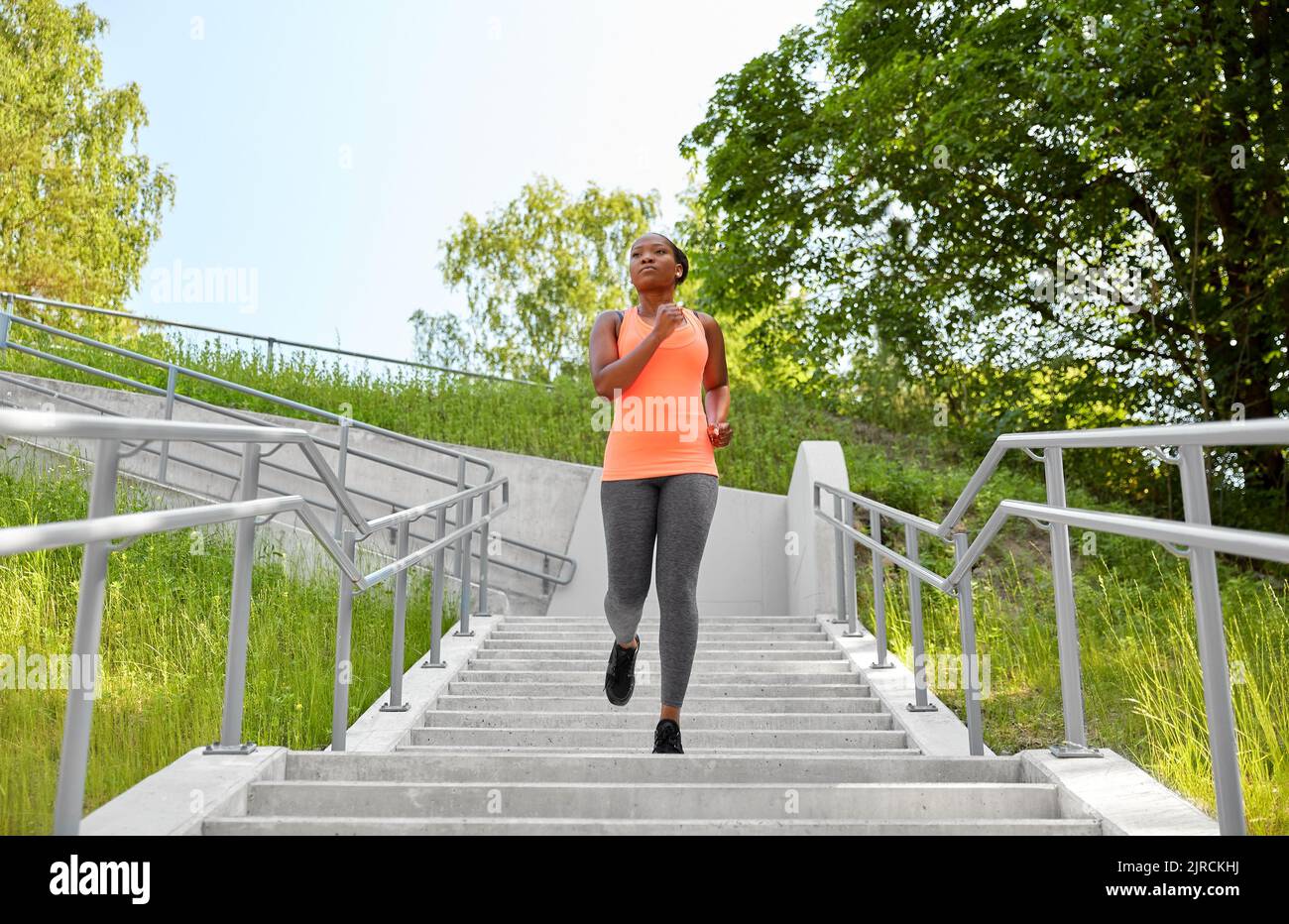 young african american woman running downstairs Stock Photo - Alamy