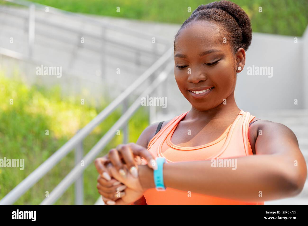 happy african woman with fitness tracker outdoors Stock Photo - Alamy