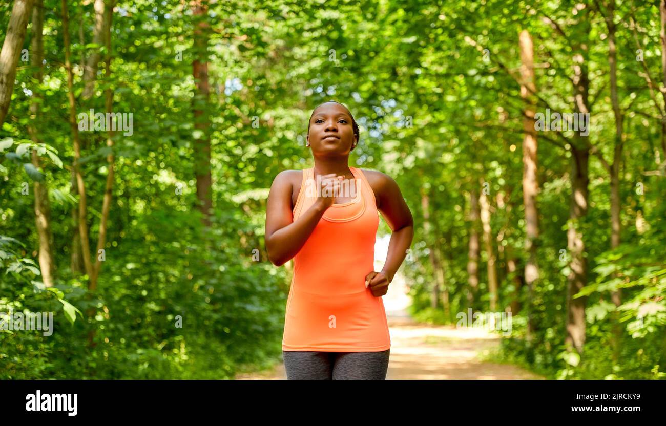 young african american woman running in forest Stock Photo - Alamy