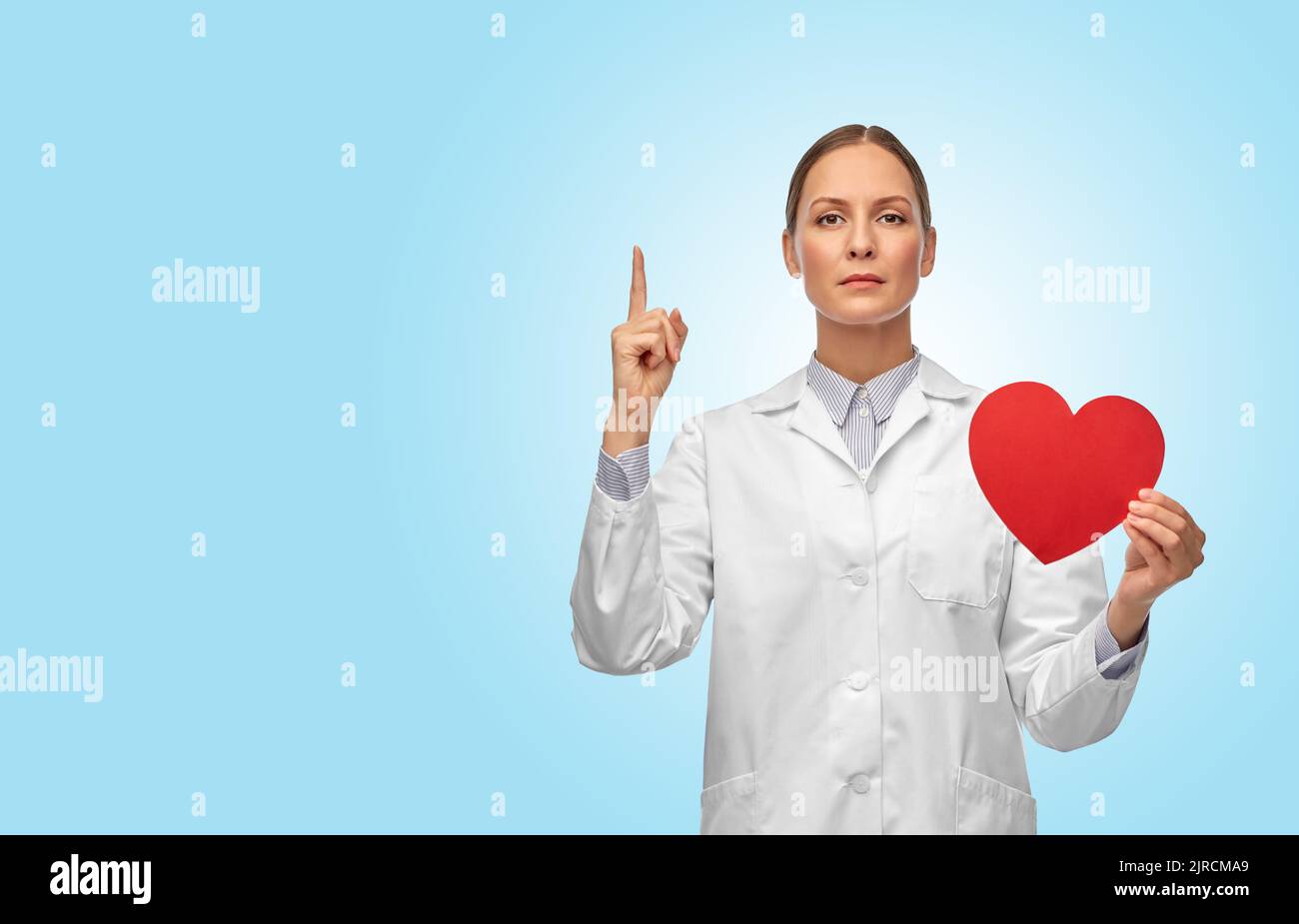 female doctor with heart pointing finger up Stock Photo - Alamy