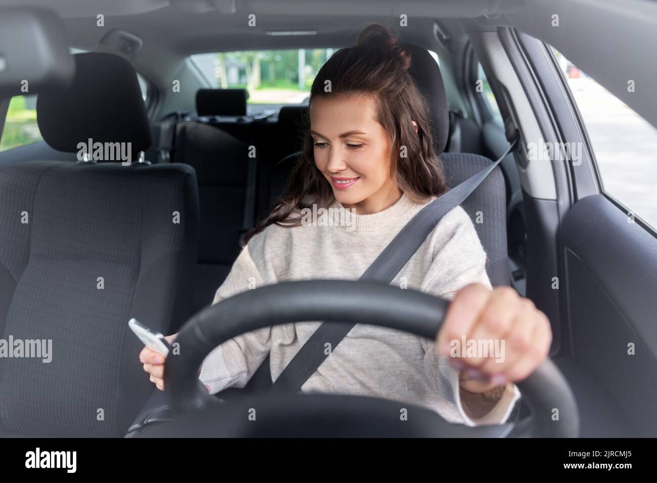 Female driver texting hi-res stock photography and images - Alamy