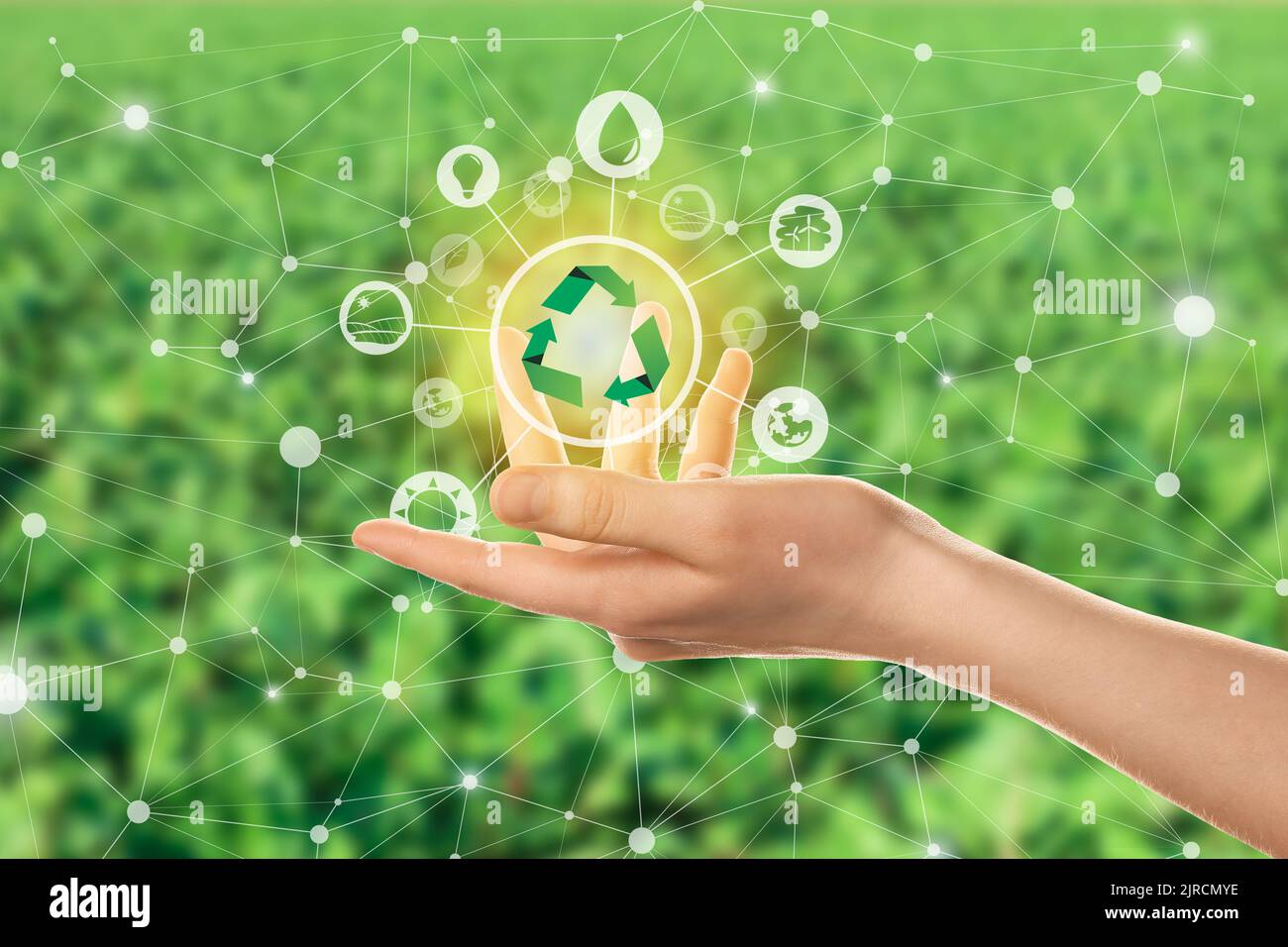 Female hand with digital icons and recycling symbol on blurred green ...