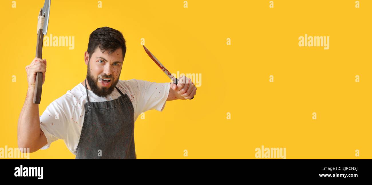 Man dressed as butcher for Halloween on yellow background with space ...