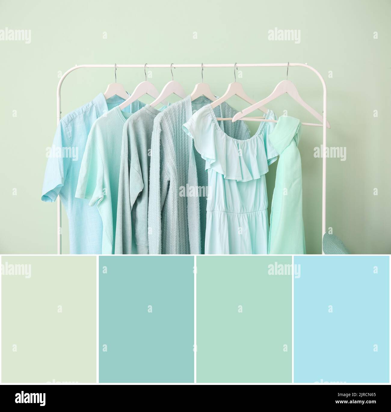 Rack with blue clothes on mint background. Different color patterns ...