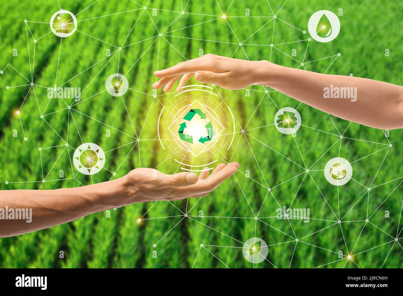 Female and male hands with digital icons and recycling symbol on blurred green background ...