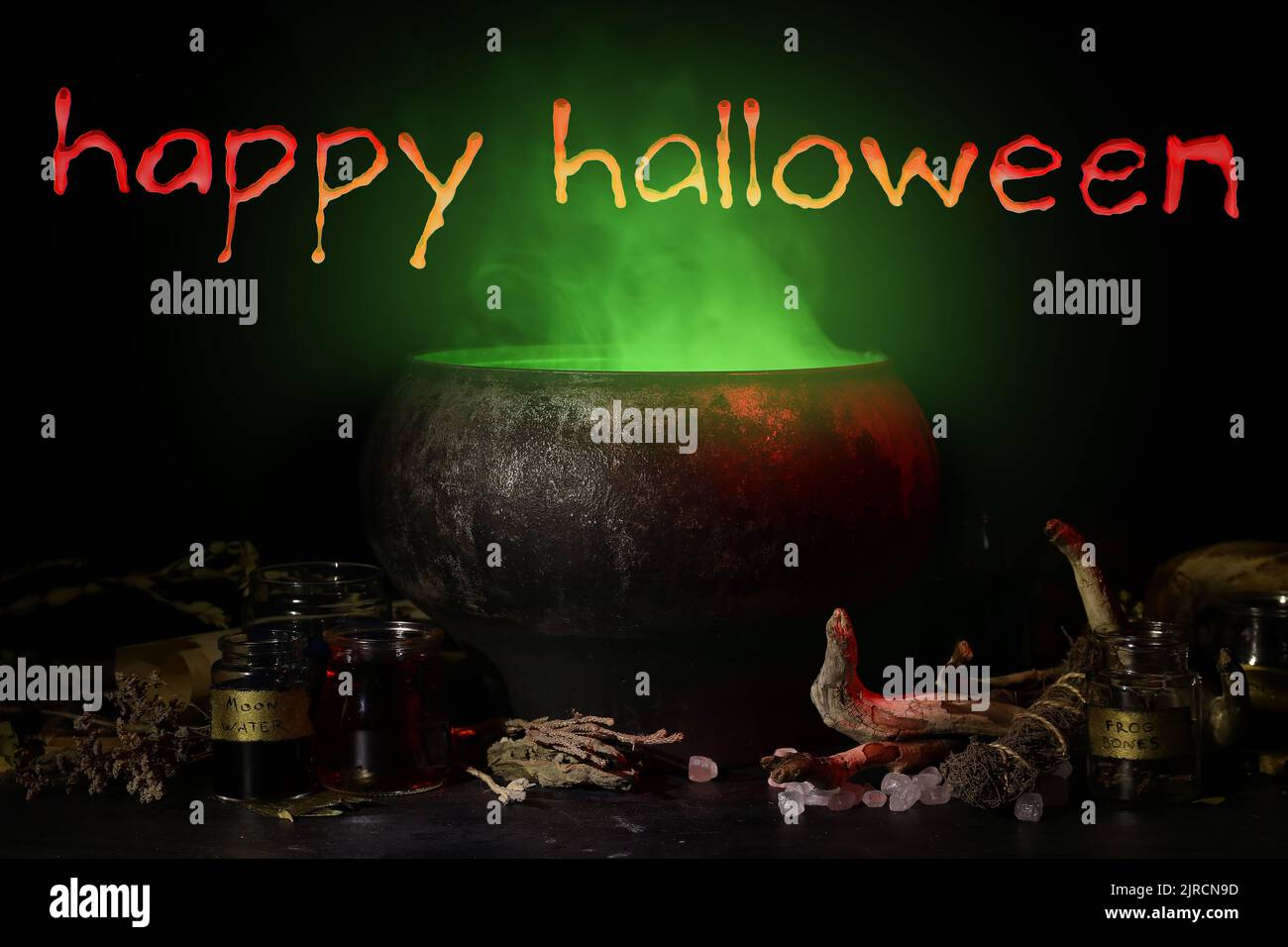 Witch's cauldron with potion and magic attributes for ritual on dark ...