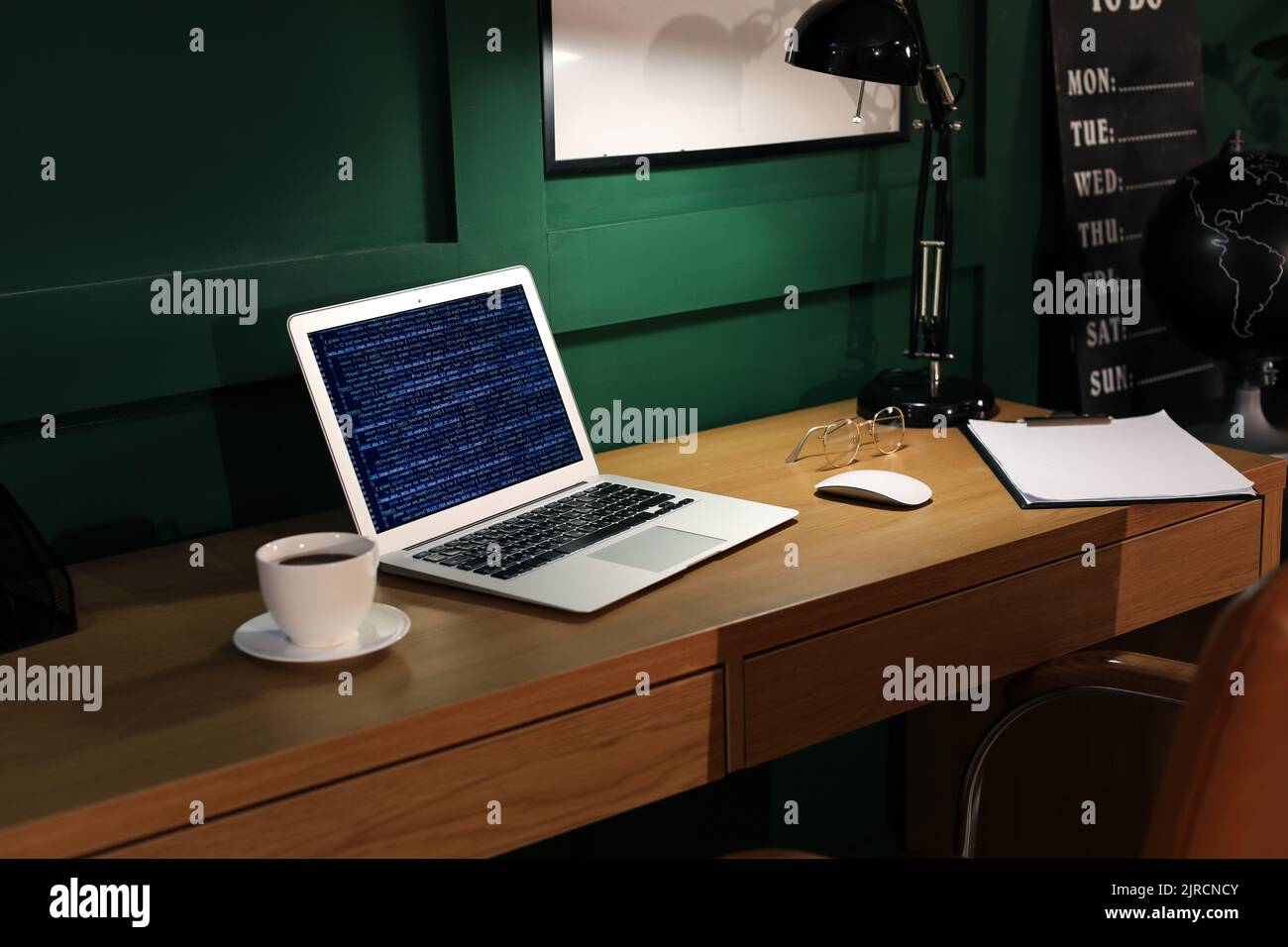 Laptop and cup of coffee on table of programmer Stock Photo - Alamy