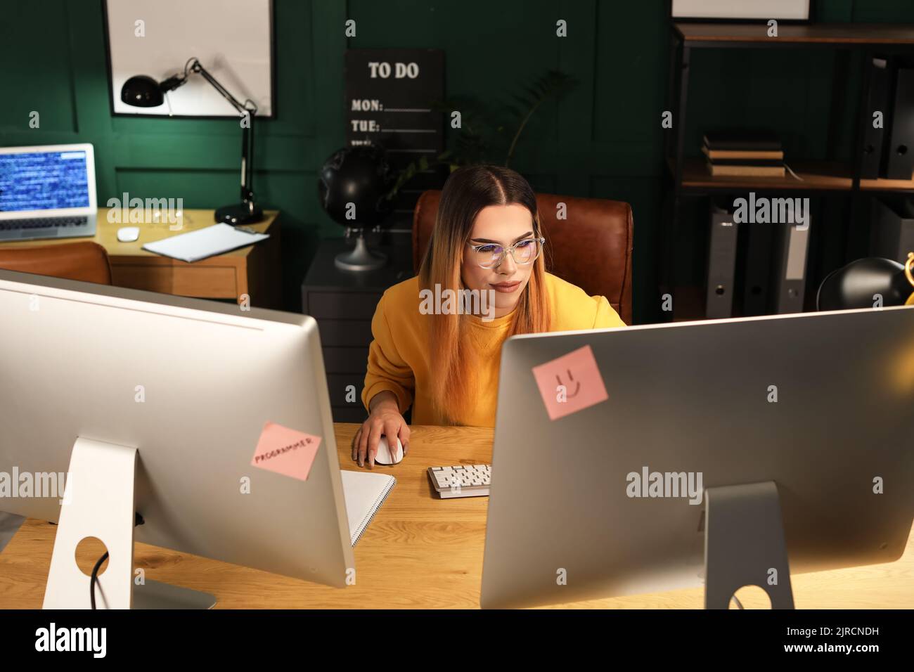 Transgender programmer working in server room Stock Photo - Alamy