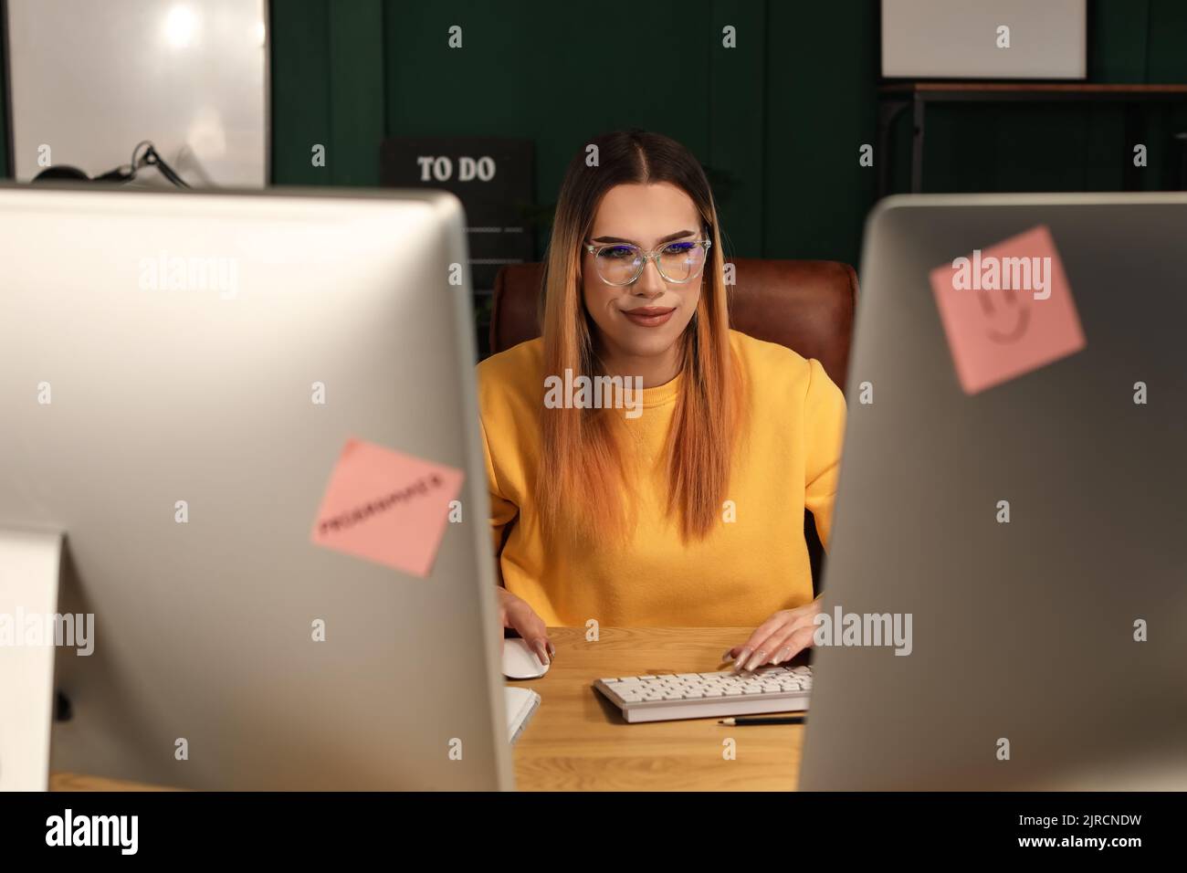 Transgender programmer working in server room Stock Photo - Alamy