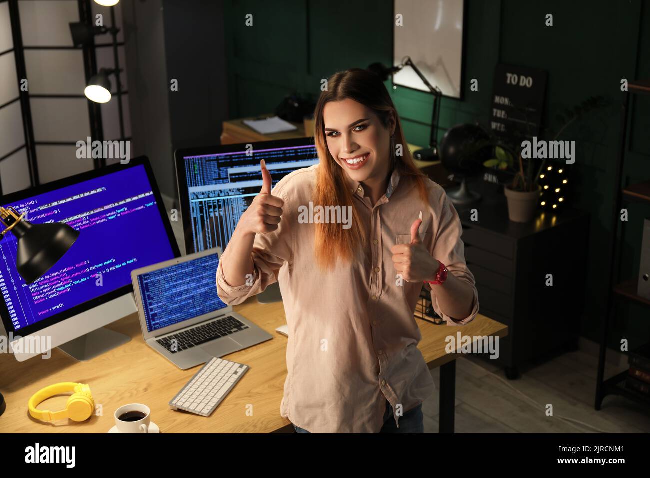 Transgender programmer working in server room Stock Photo - Alamy