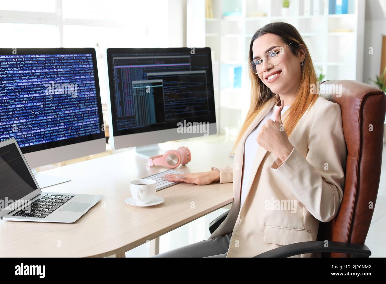 Transgender programmer working in office Stock Photo - Alamy