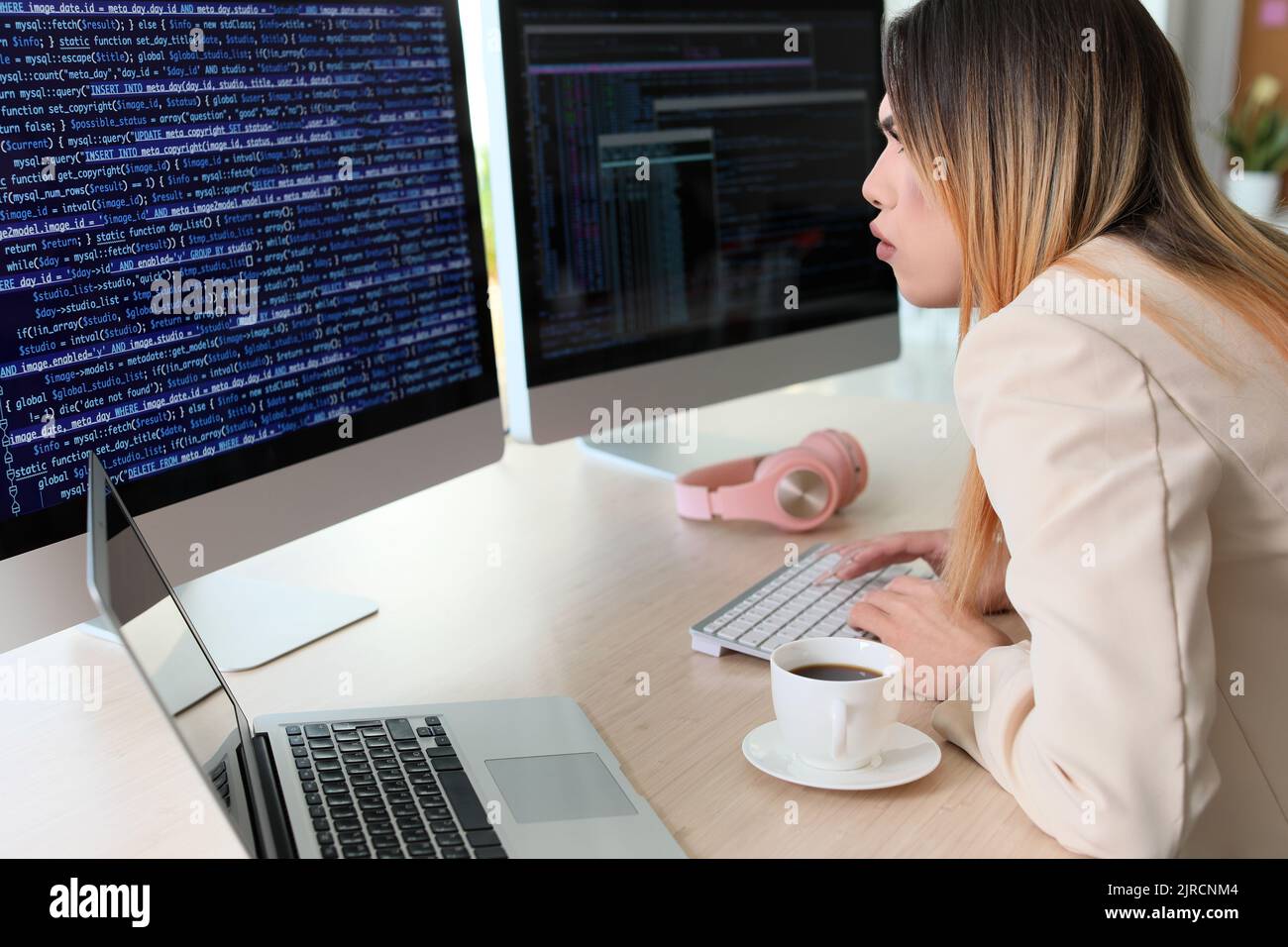 Transgender programmer working in office Stock Photo - Alamy
