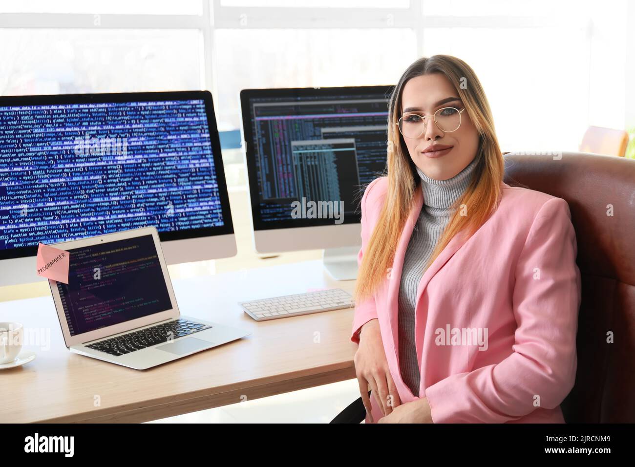 Transgender programmer working in office Stock Photo - Alamy