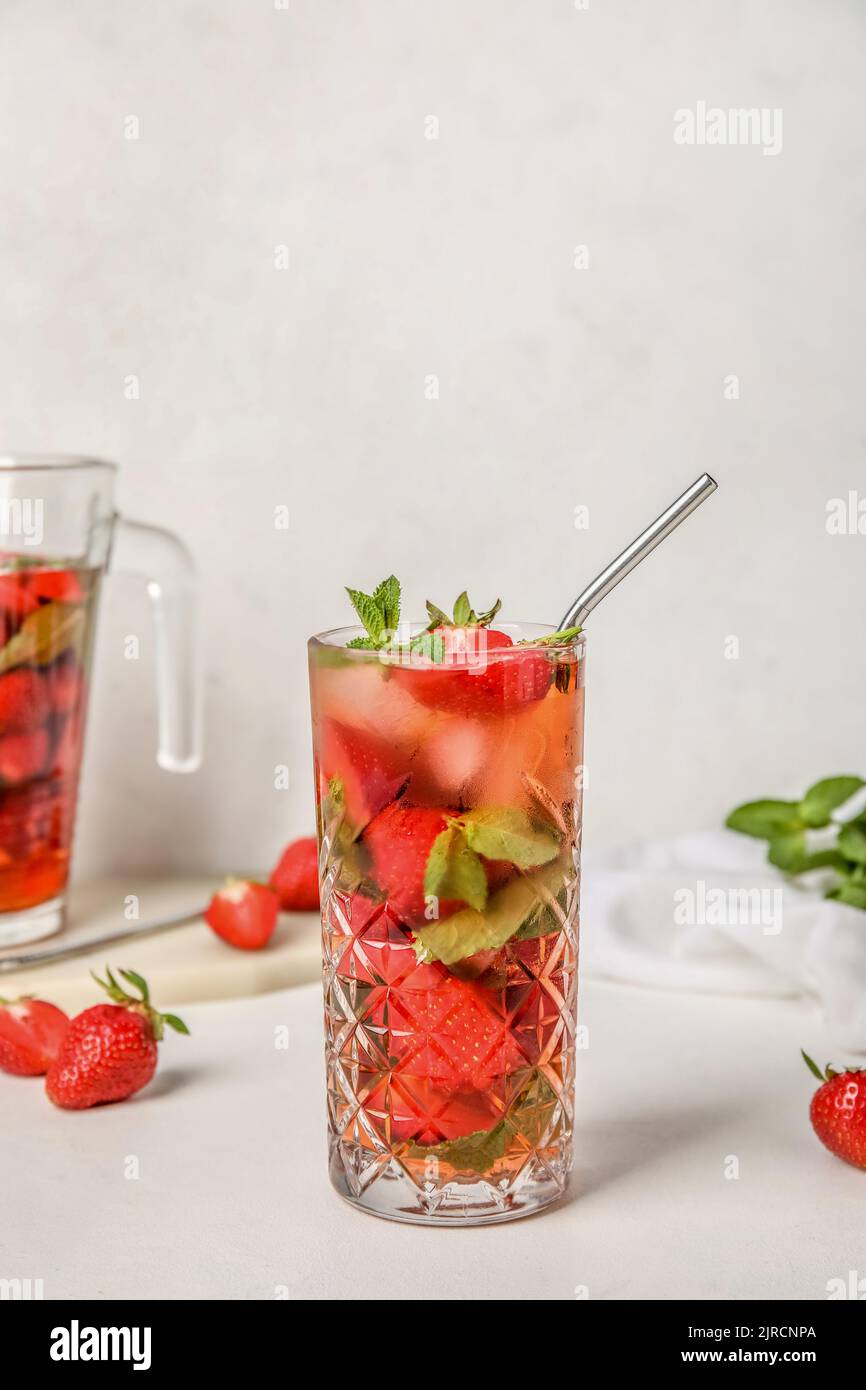 Glass of strawberry lemonade with straw on white background Stock Photo ...