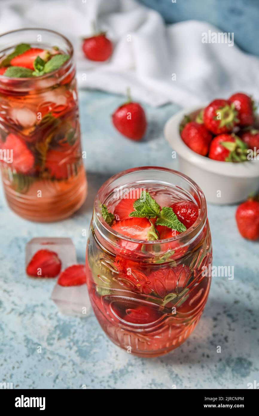 Glass of strawberry lemonade on blue background, closeup Stock Photo ...