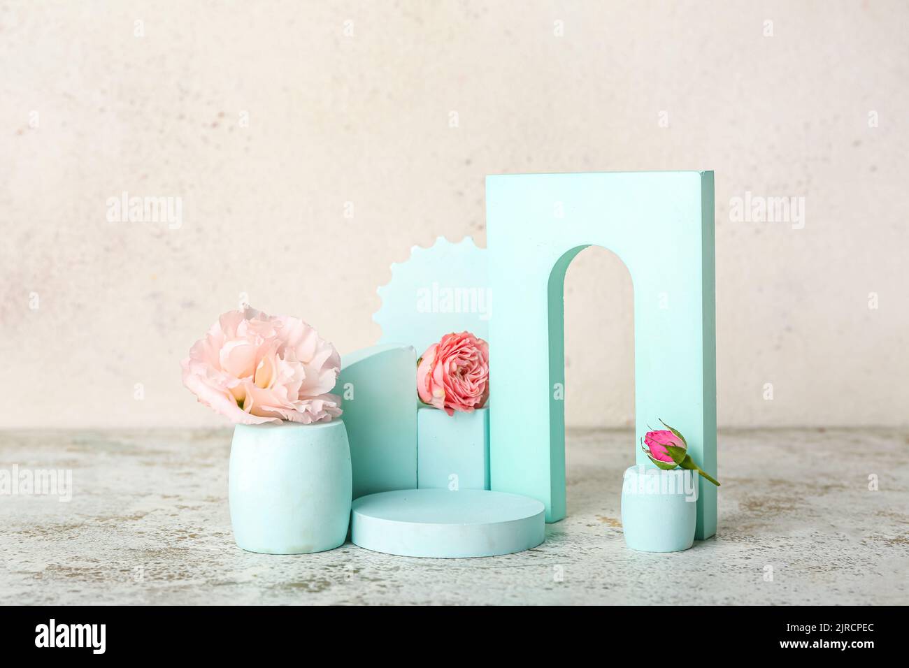 Decorative stands with beautiful flowers on light background Stock ...