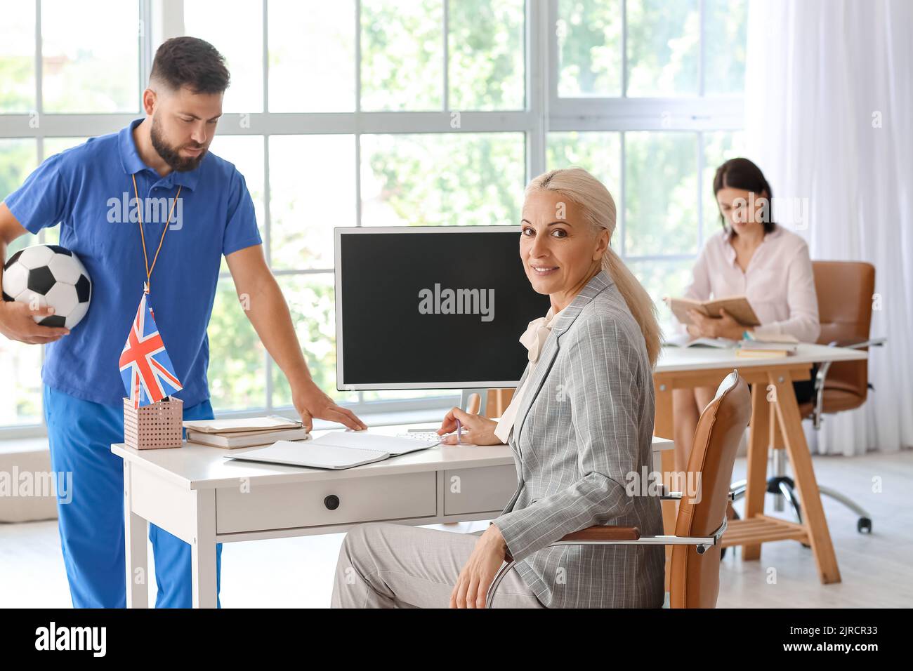 Teachers working in school office Stock Photo - Alamy