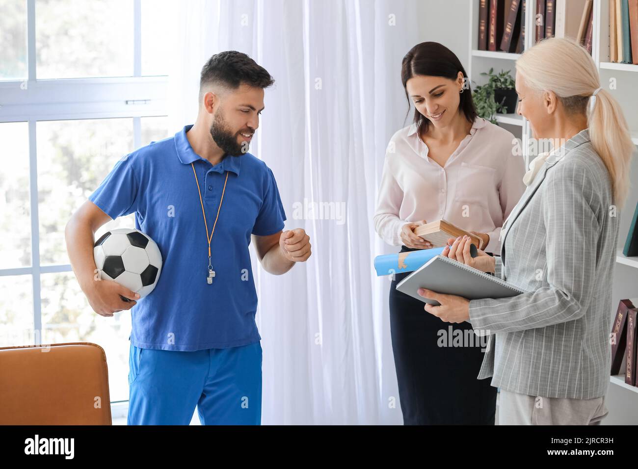 Teachers with world map in school office Stock Photo - Alamy
