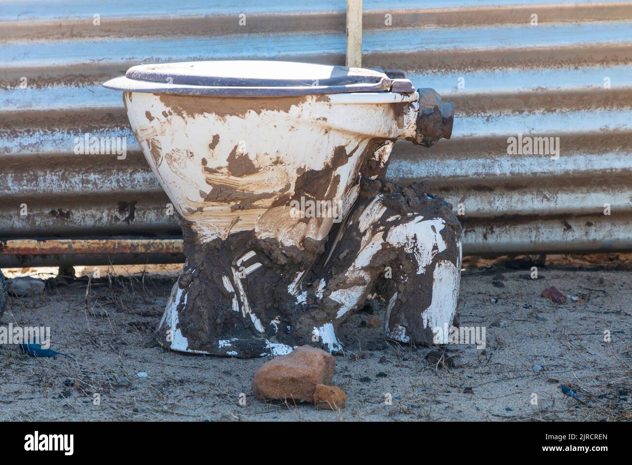 Photograph of a toilet covered in mud caused by severe flooding in the ...