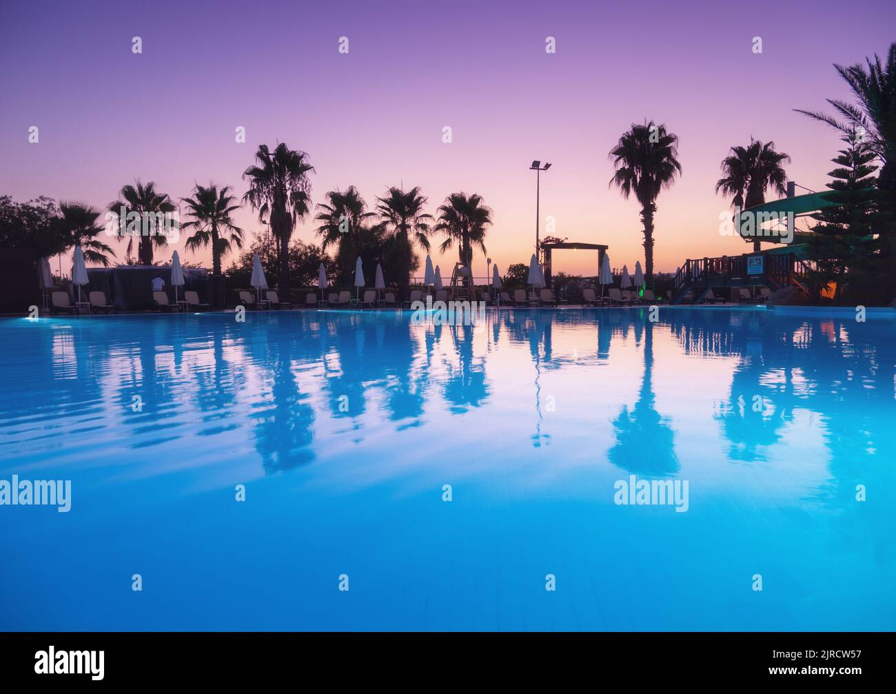 Beautiful reflection in swimming pool at colorful sunset Stock Photo ...