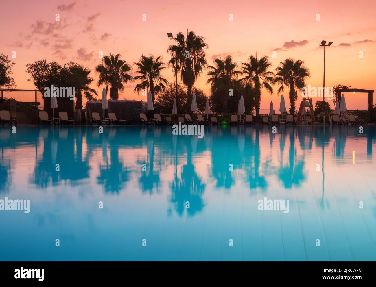Beautiful reflection in swimming pool at colorful sunset Stock Photo ...