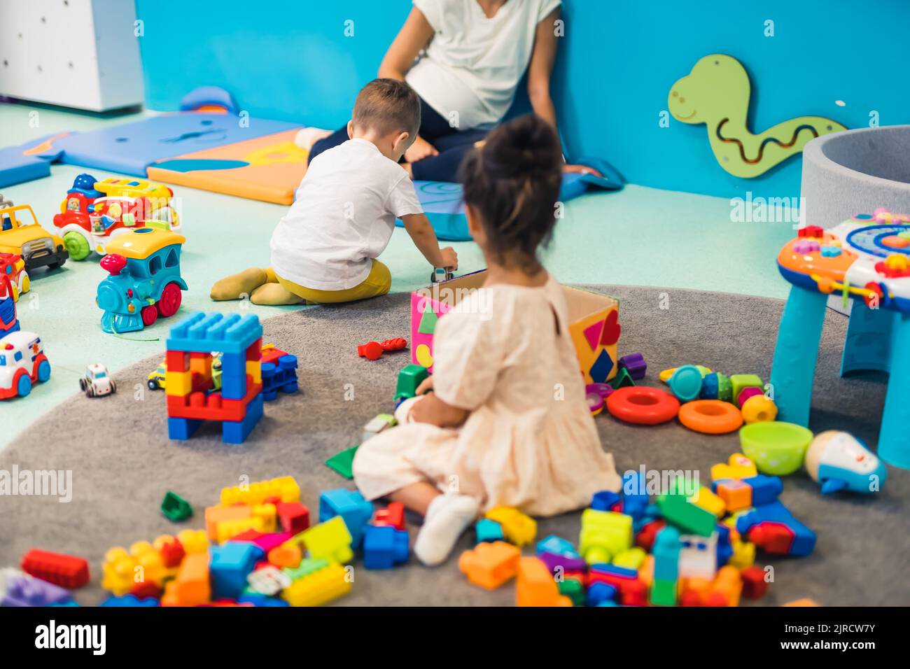 Creative playtime at nursery school. Toddlers playing with plastic ...