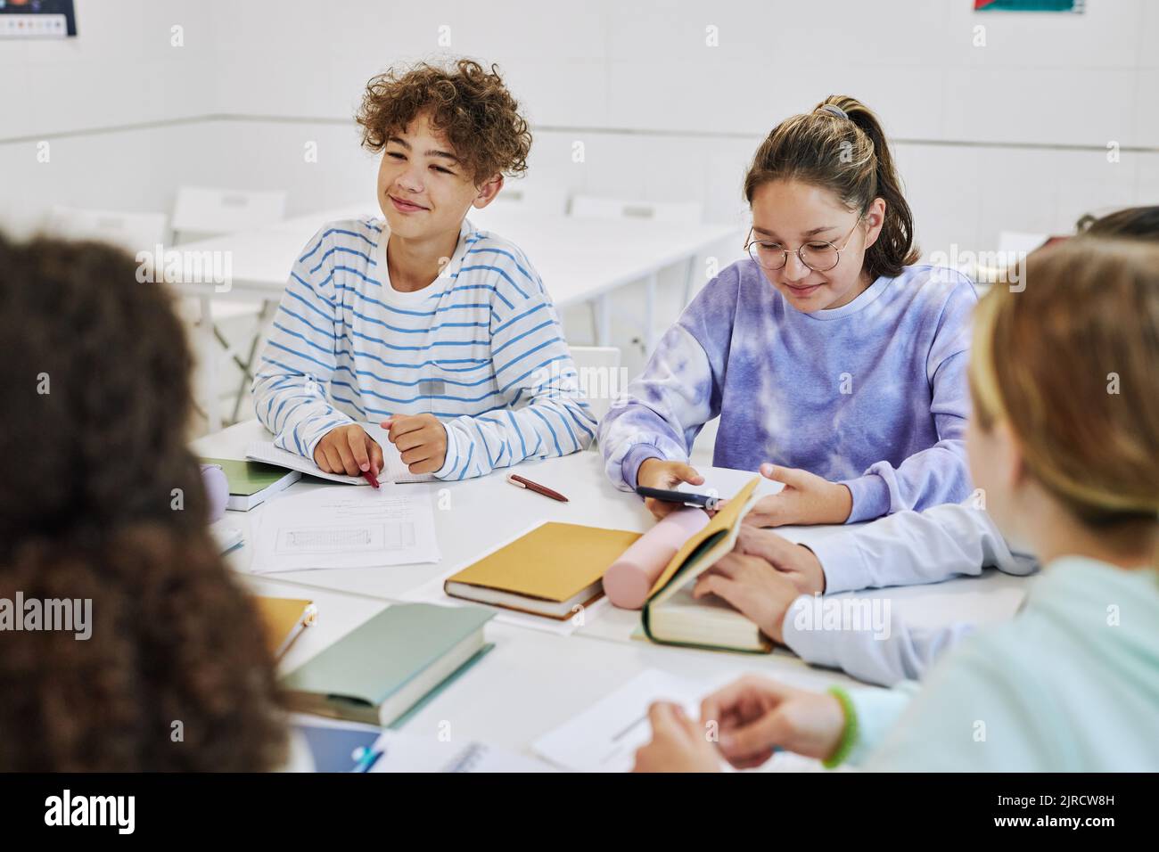 Diverse children in group activity in school classroom with focus on ...