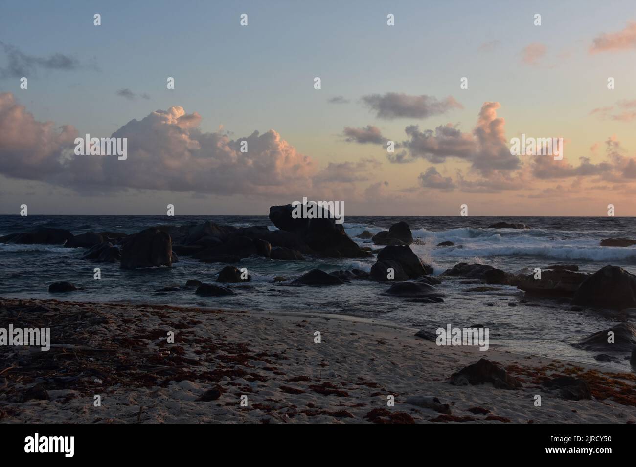 Gorgeous sunrise seascape with rugged rocks exposed in ocean Stock ...