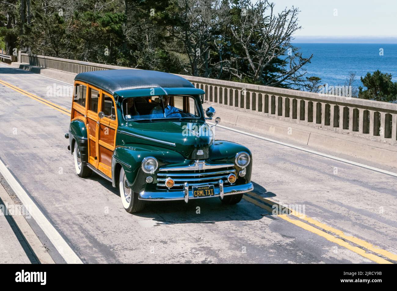 Ford Woody station wagon driving the Pebble Beach tour on HWY1 Carmel ...