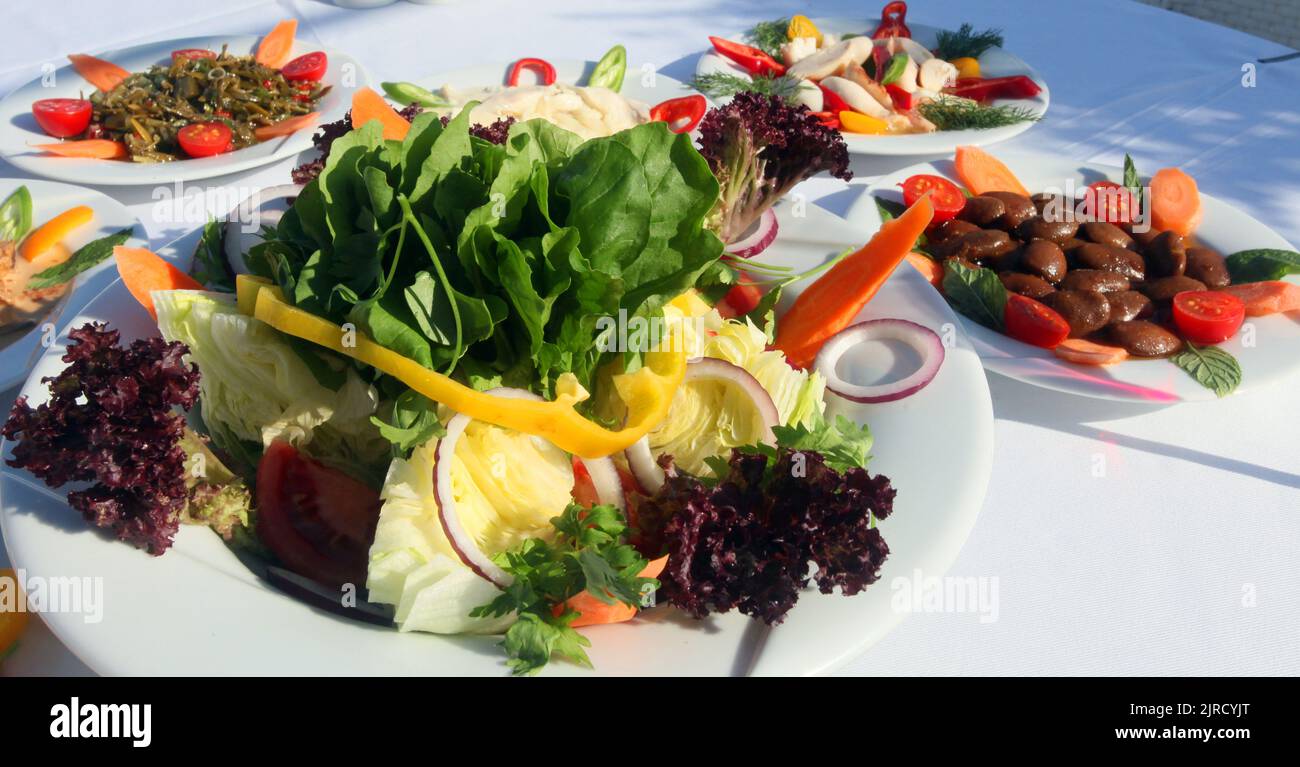 Fresh salad and traditional Turkish appetizer foods (Turkish meze) on ...