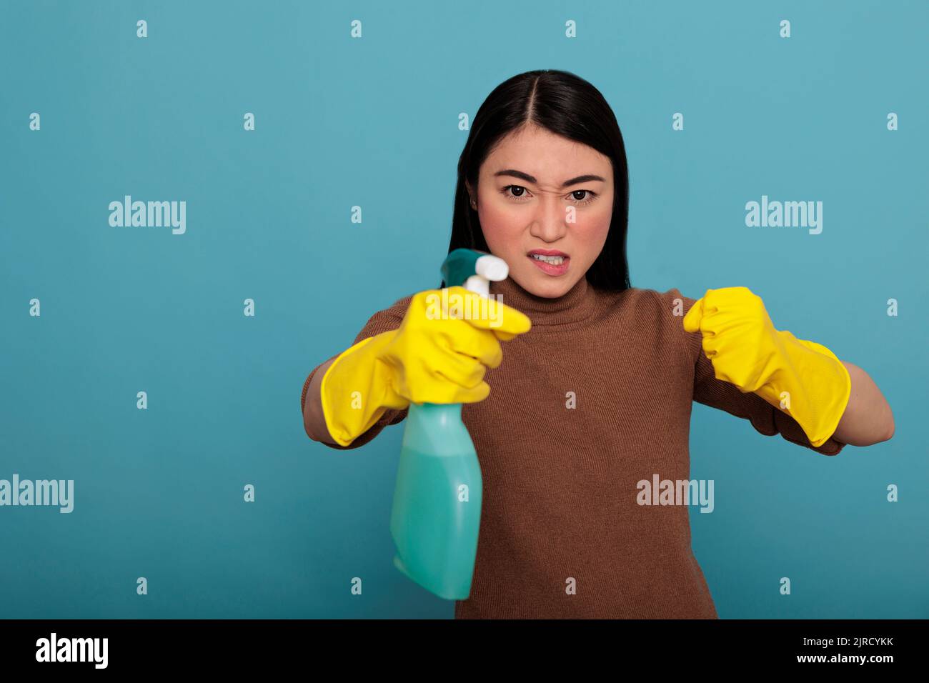 Excited energetic asian young housekeeper in rubber gloves and ...