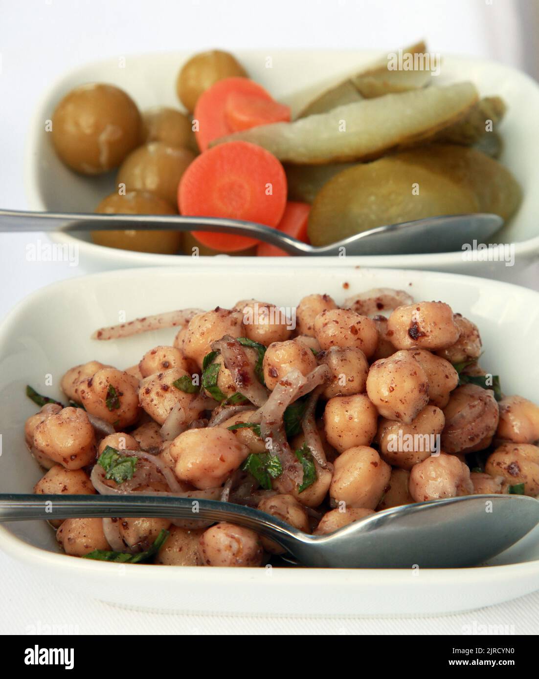 Turkish appetizer food 'Chickpeas cold cuts' and pickles on the dinner ...