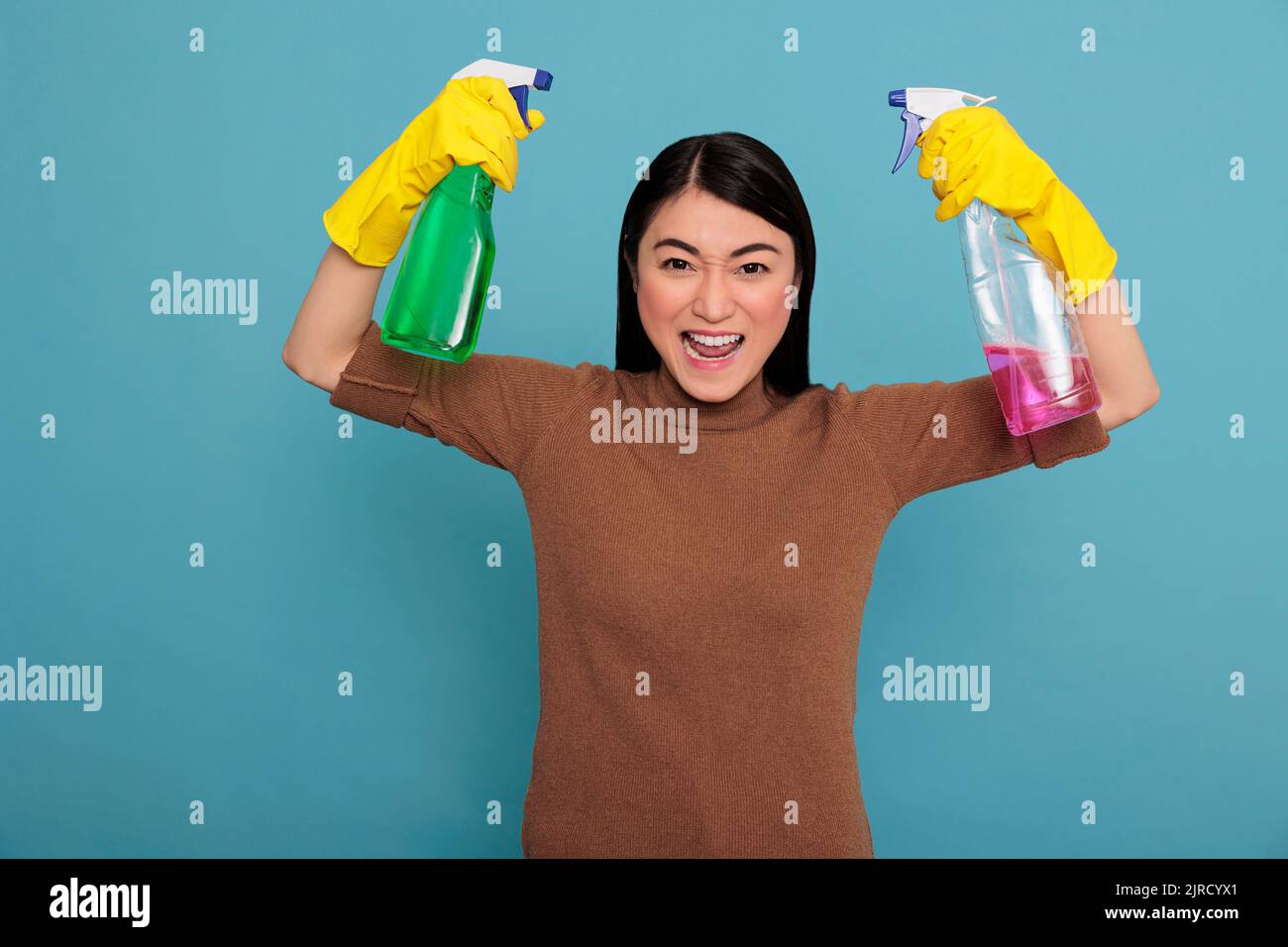 Happy excited and smiling asian housewife raising arms and showing ...