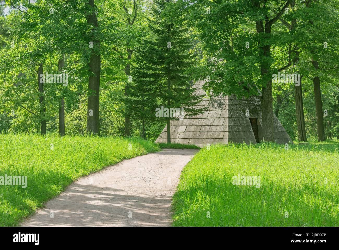 Narrow walkway and stone pyramid in the summer city park Stock Photo ...