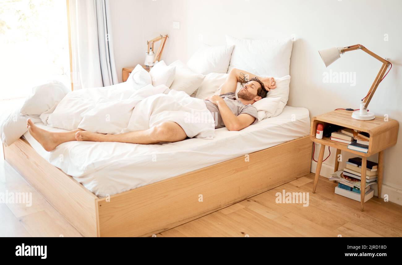 Relaxed man sleeping in bed at home, tired person having dream in ...