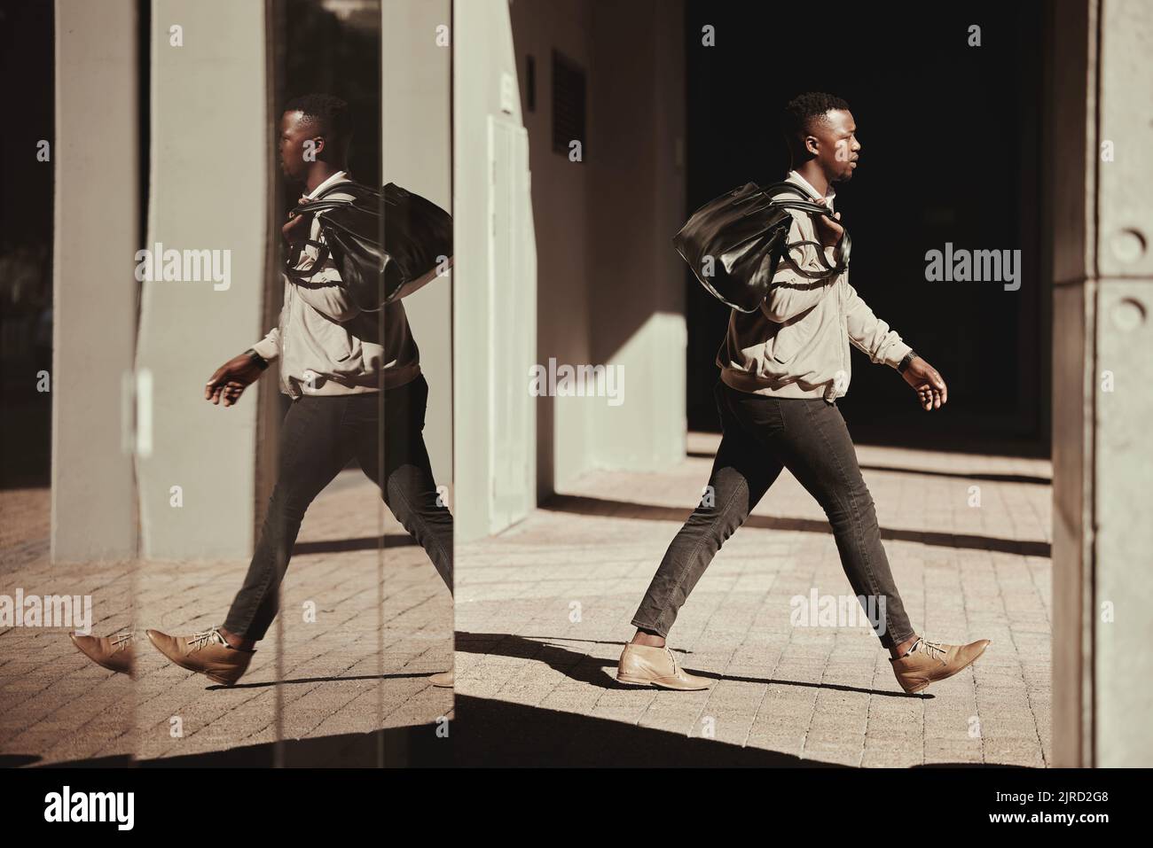 Stylish, travel and a trendy young man walking out of a building or ...