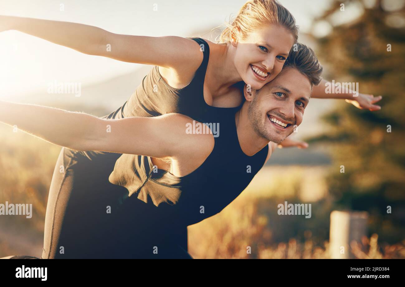 Together we soar. a young woman being piggybacked by her boyfriend ...