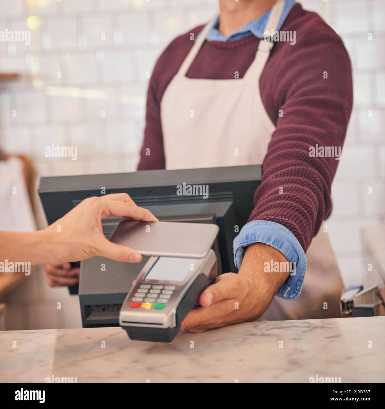 Making payments even simpler. an unidentifiable woman making a payment ...