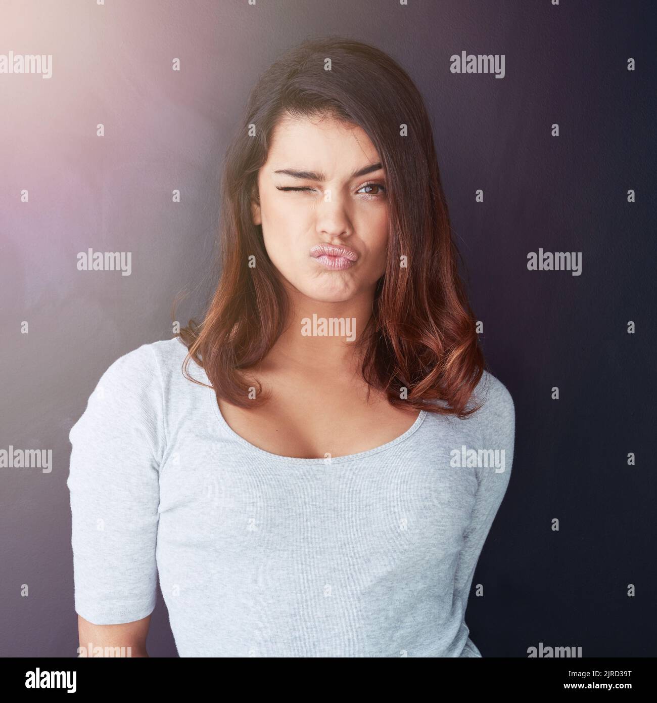 Flirtatious young woman winking hi-res stock photography and images - Alamy