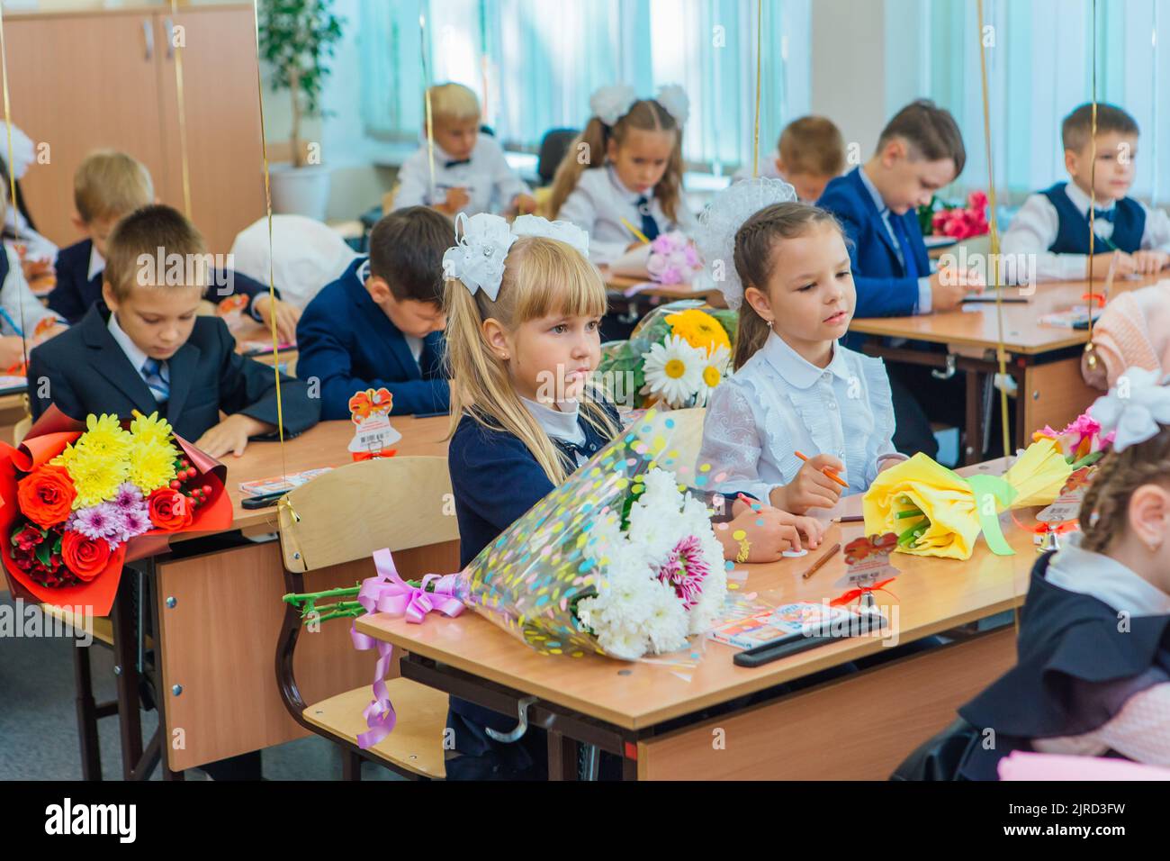 First-grade students and teacher are in school classroom at first ...